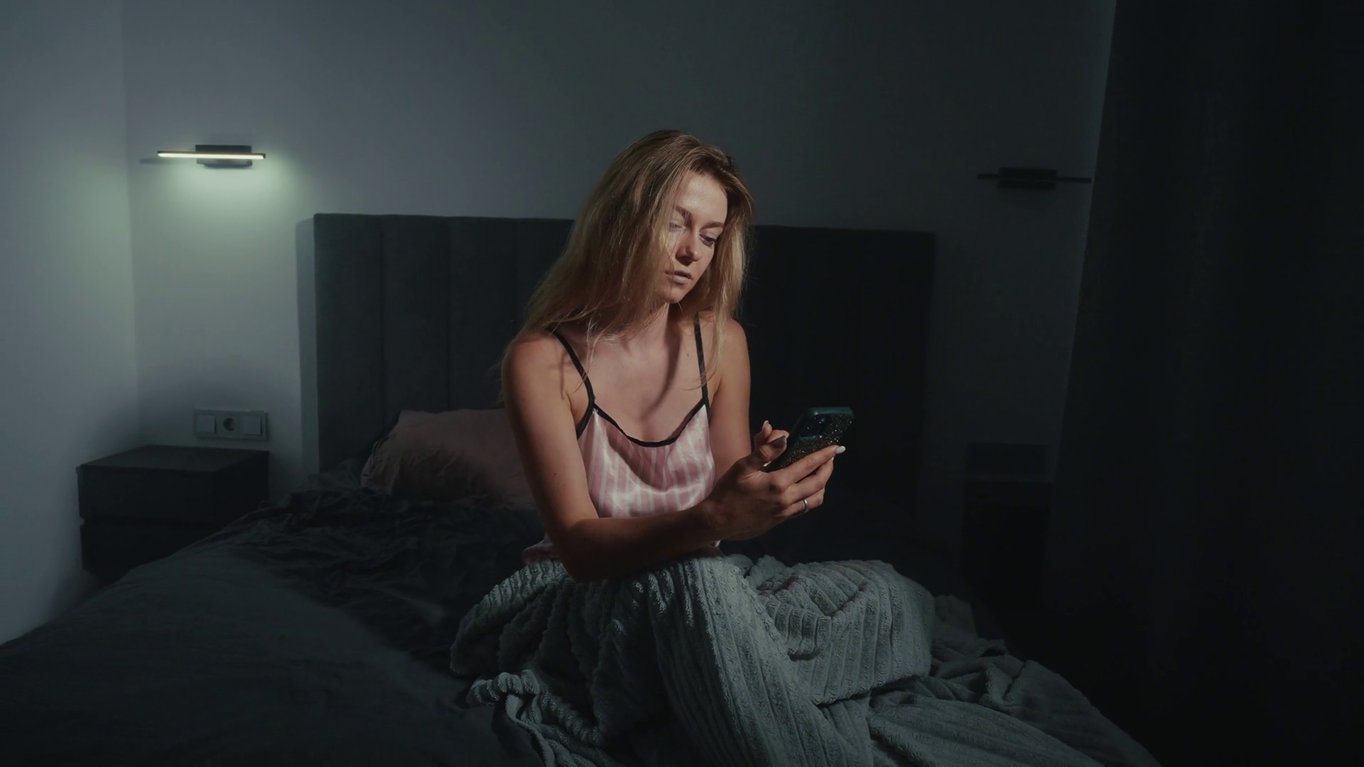 Young Woman Smiles Texting On Phone In Dimly Stock Footage SBV ...