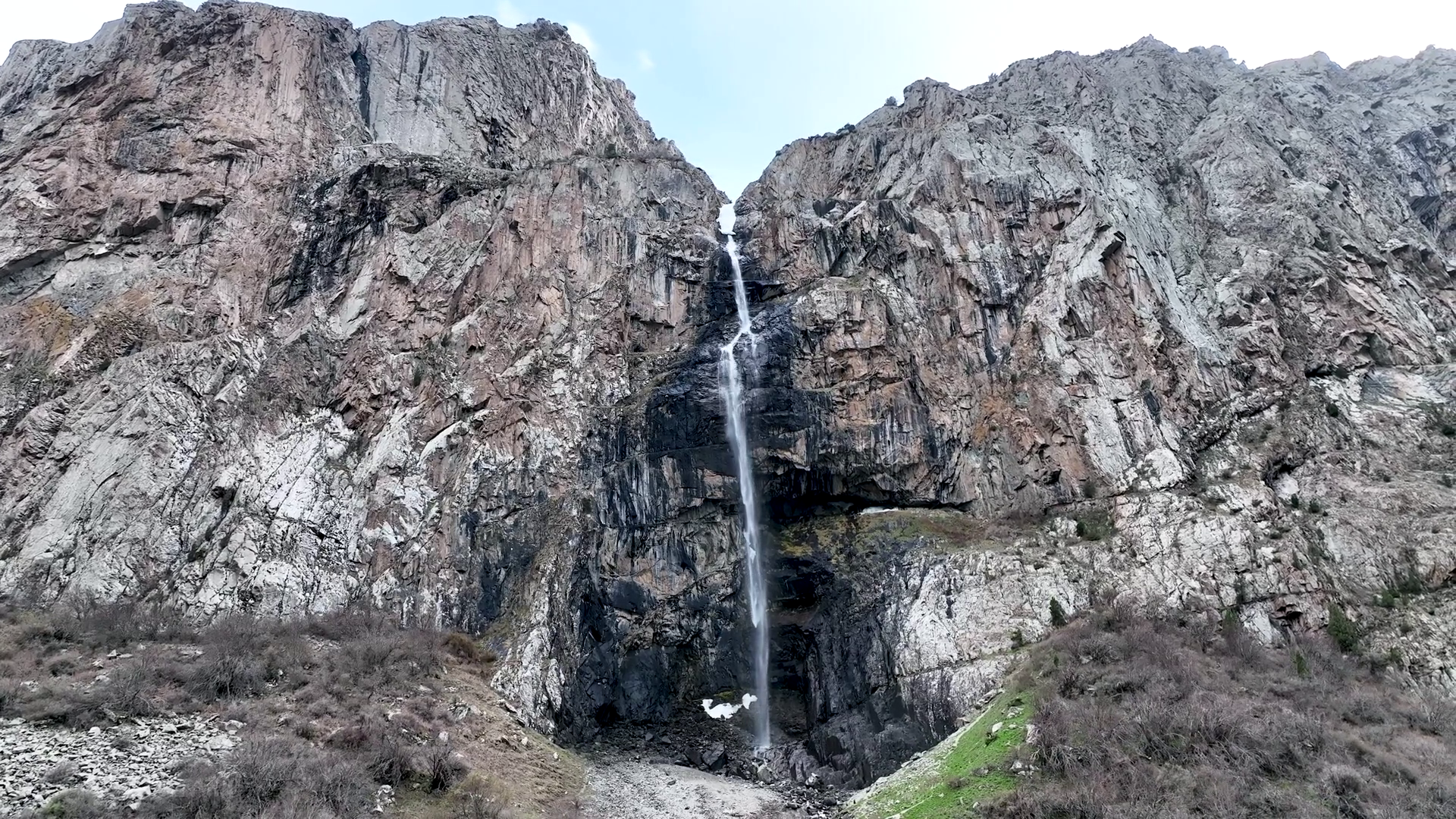 A Spectacular Narrow Waterfall Dropping From Stock Footage SBV ...