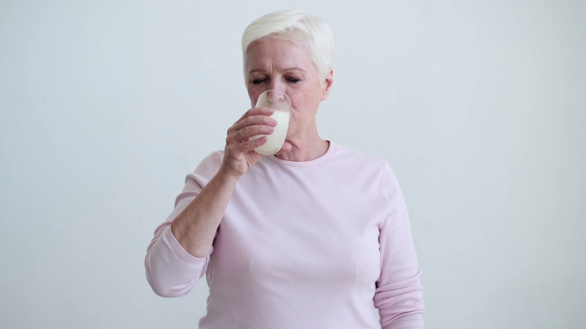 Senior Caucasian Woman Taking Sip Of Milk Stock Footage SBV-348769130 ...