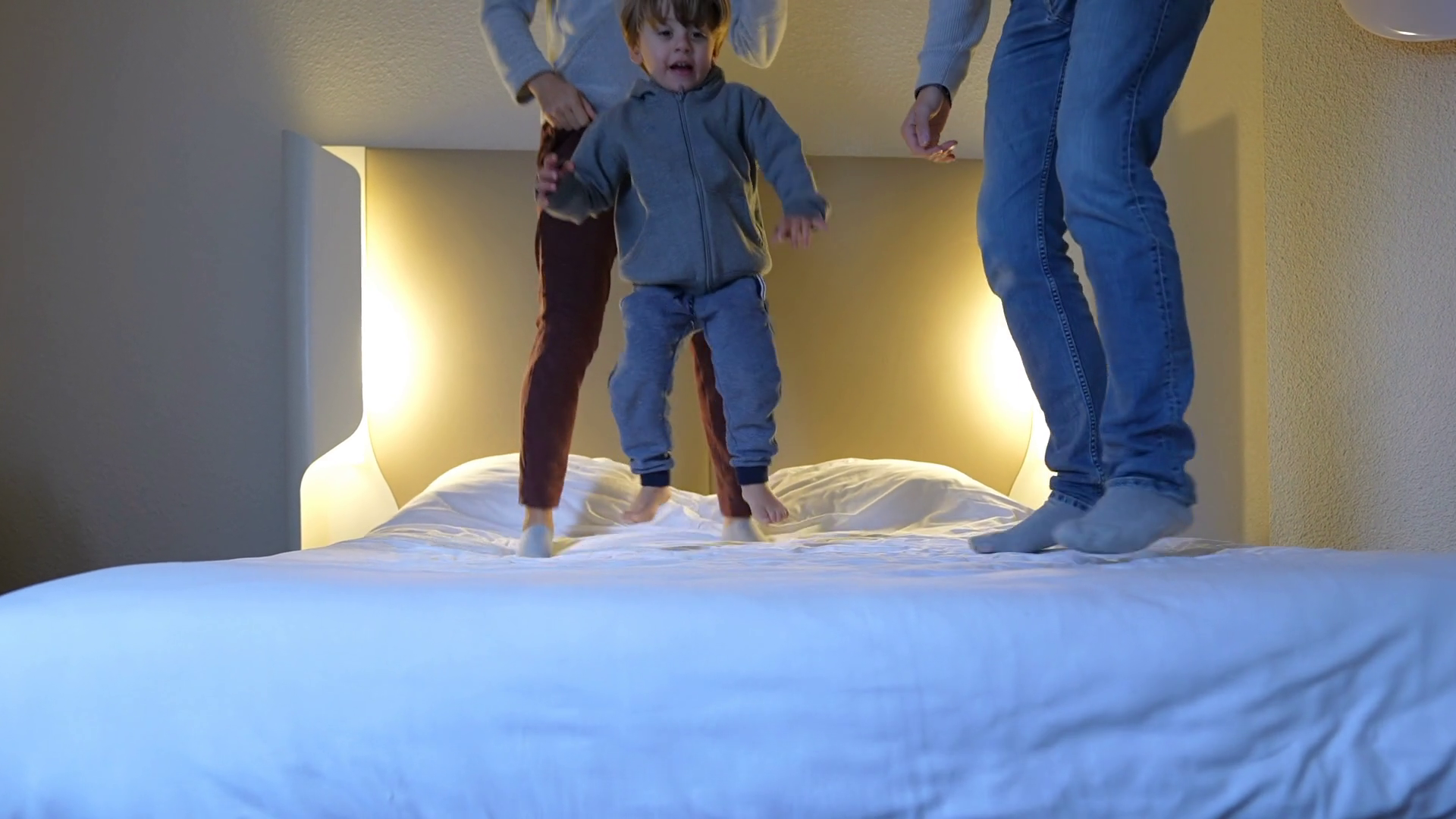 Blissful Moment Of Parents Child Bouncing In Stock Footage SBV ...