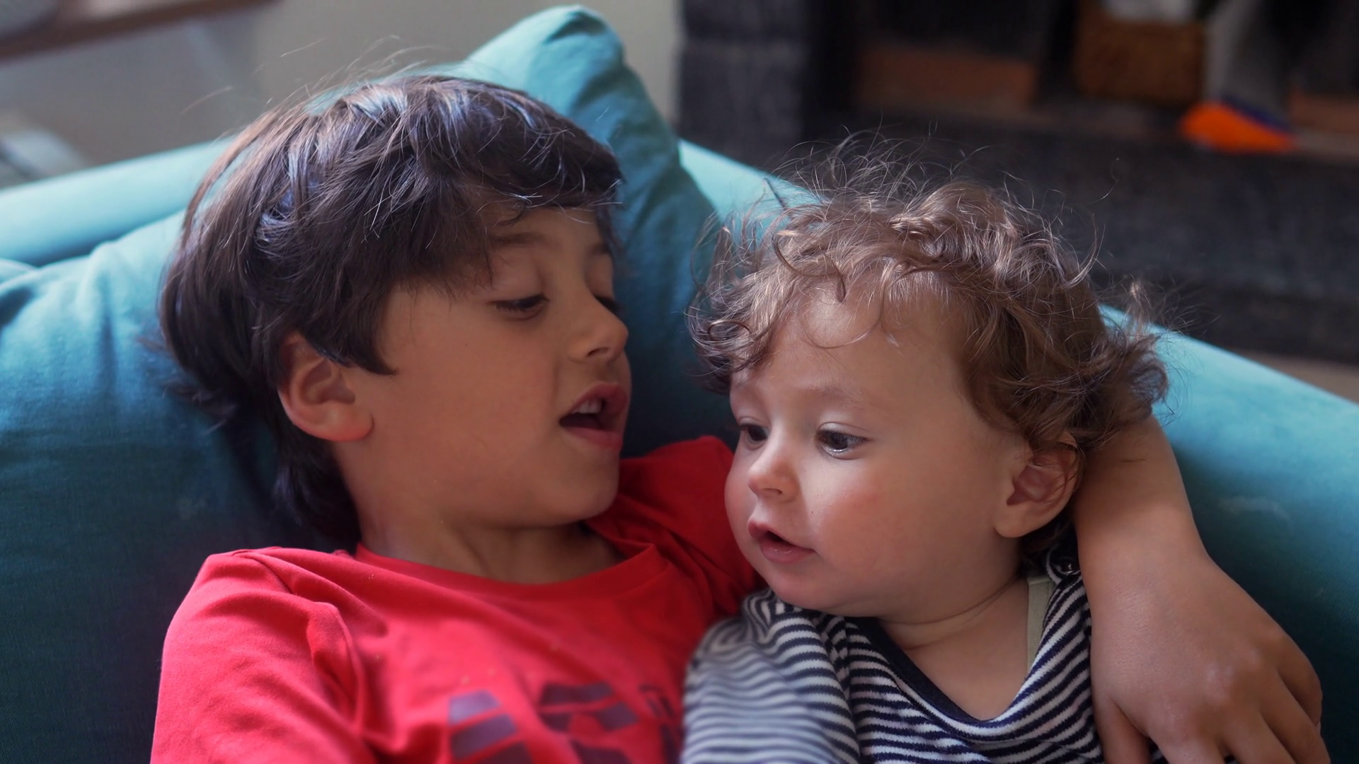 Older Sibling Holding Toddler Close On Couch Stock Footage SBV ...