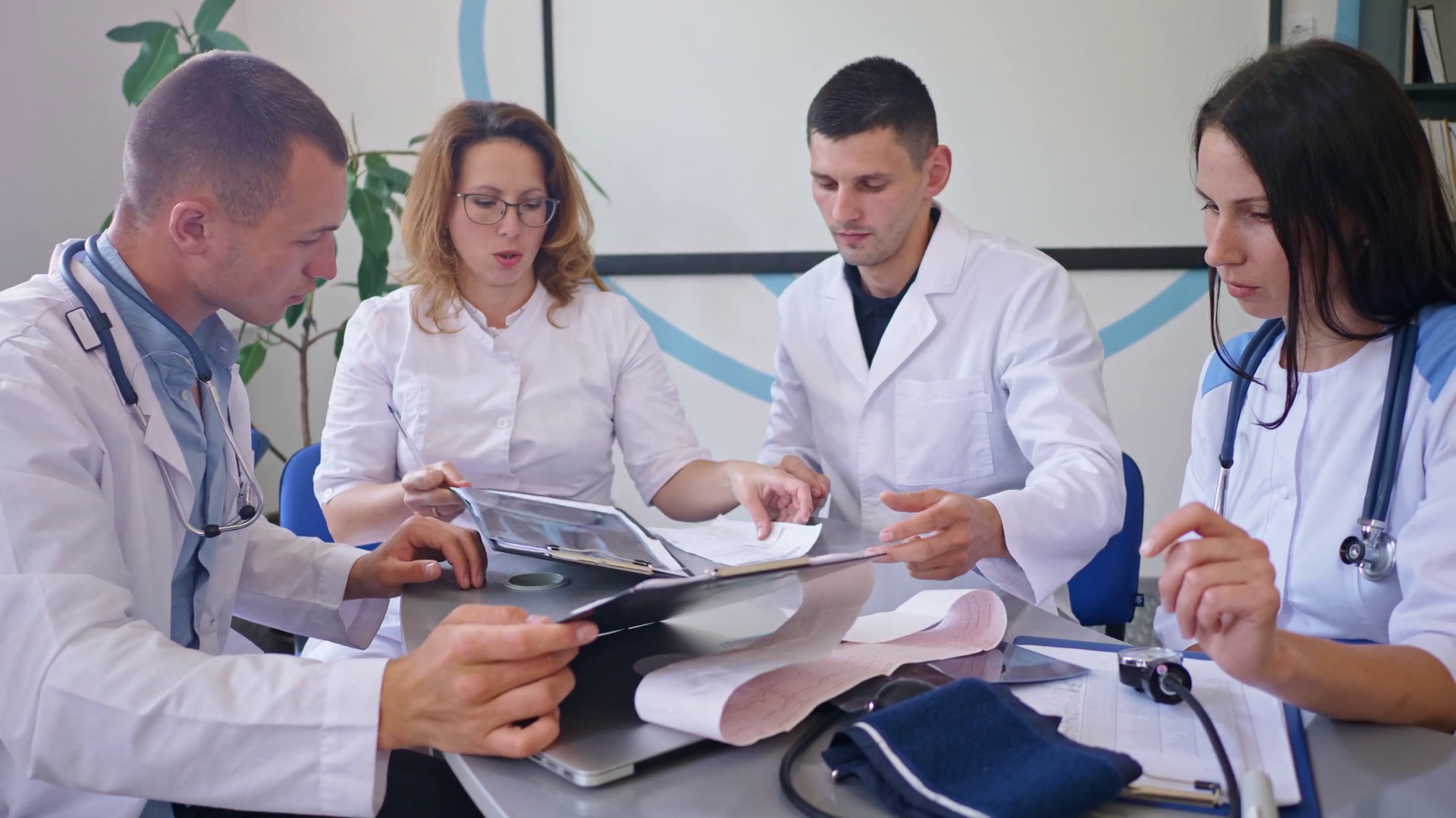 Team Of Four Doctors In White Coats Sitting Stock Footage SBV-349372409 ...