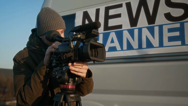 Journalist Holding Camera Stock Footage: Royalty-Free Video Clips ...