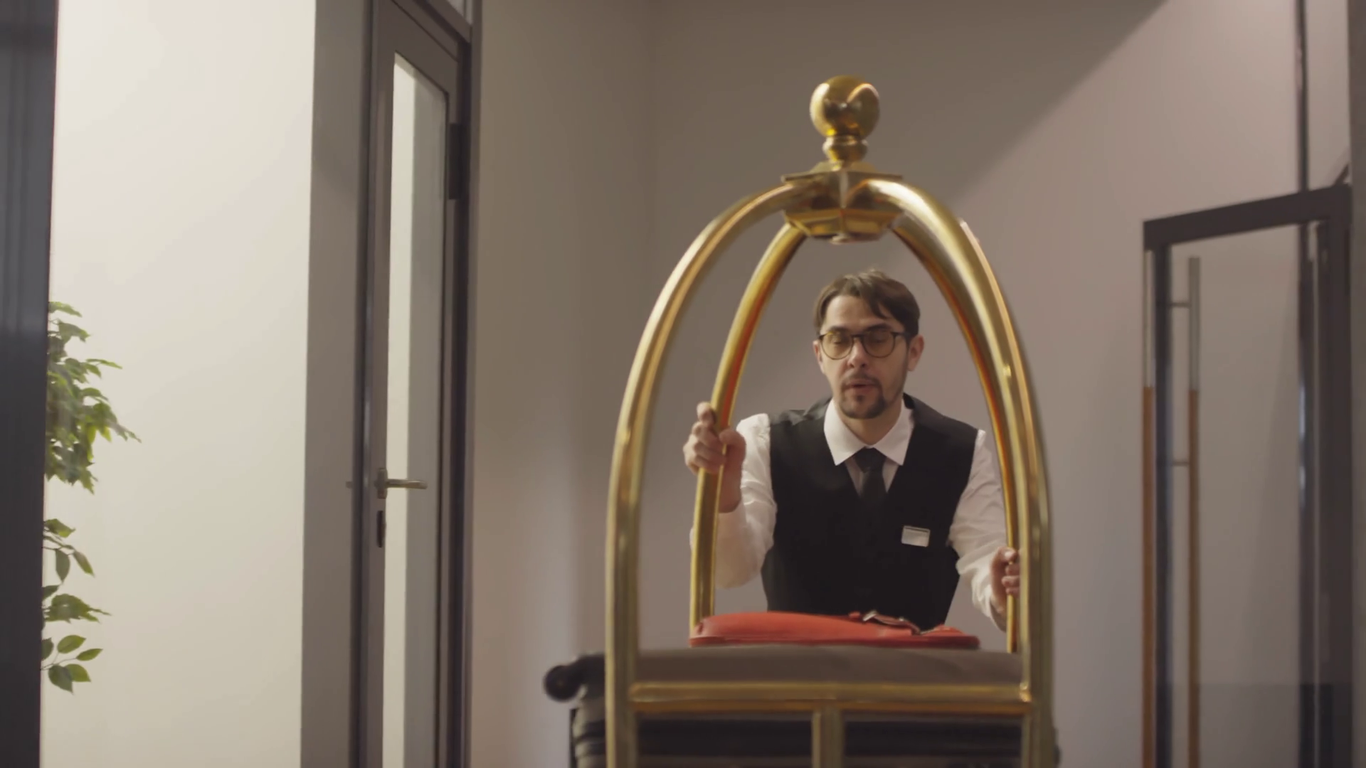 Tracking Shot Of Male Bellhop In Uniform Stock Footage SBV-338117173 ...