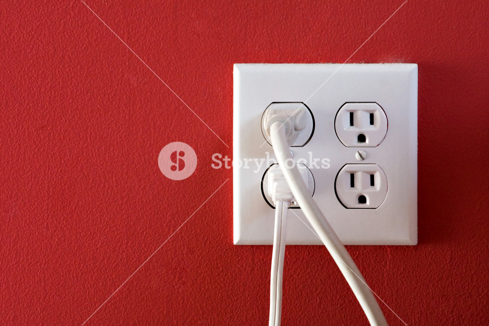 Electrical outlets with four spaces and two of them have chords plugged ...
